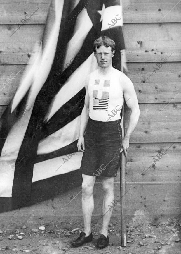 El atleta norteamericano Thomas Pelham Curtis posa junto a la bandera ...